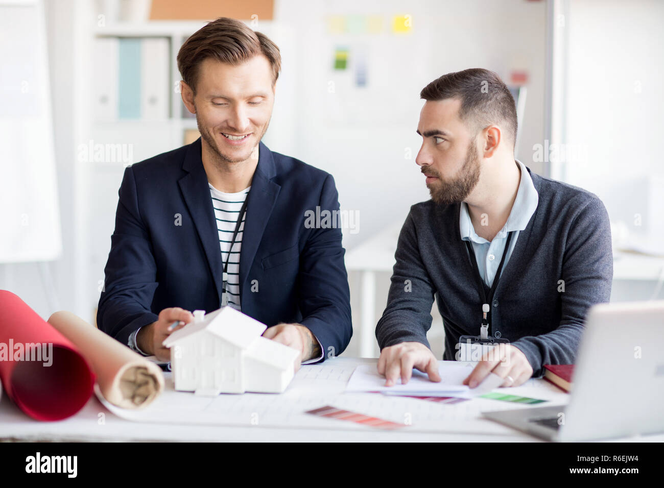 Male Designers Discussing House Stock Photo - Alamy