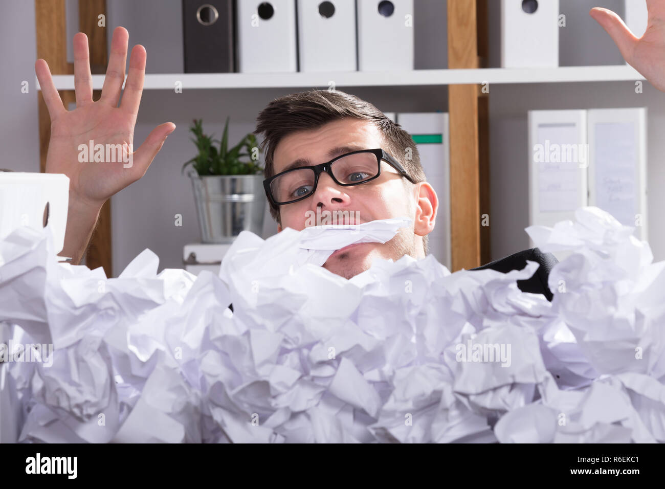 Close-up Of Businessman Behind Heap Of Crumpled Paper Stock Photo - Alamy