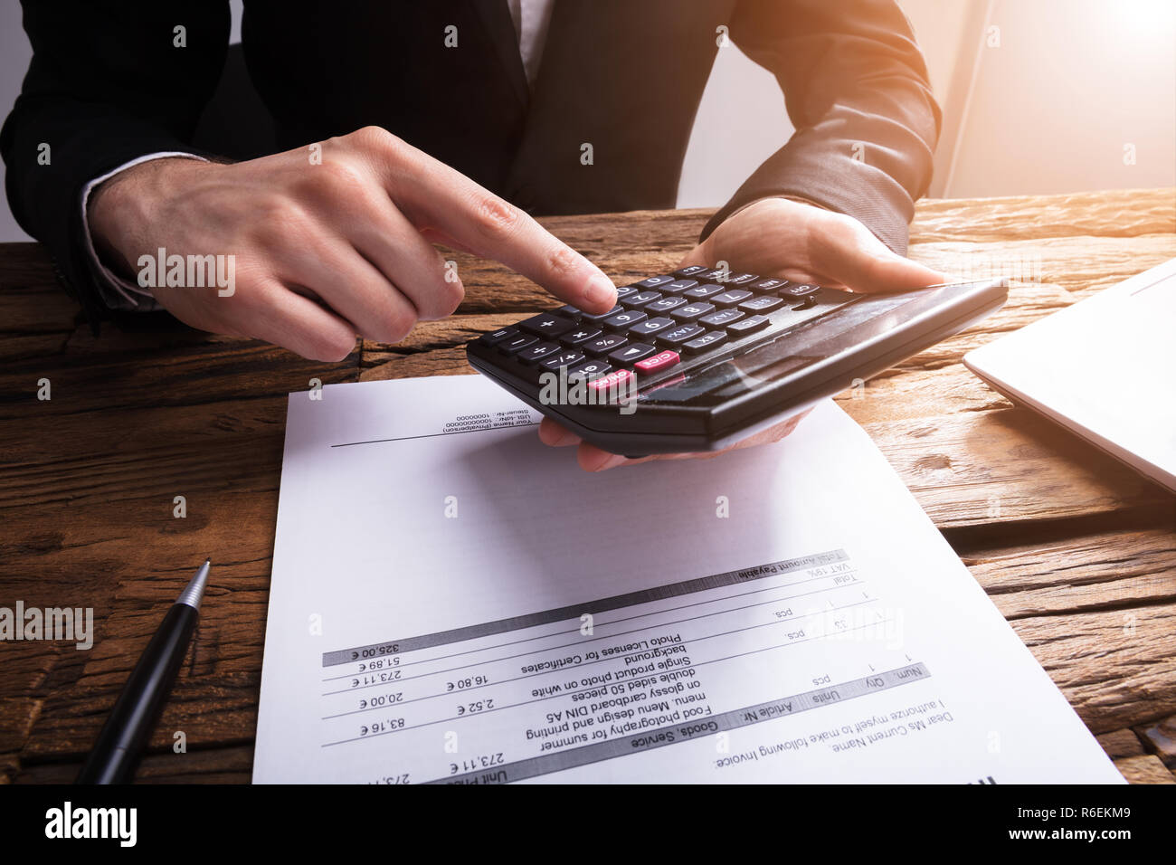 Businessperson Calculating Bill With Calculator Stock Photo - Alamy