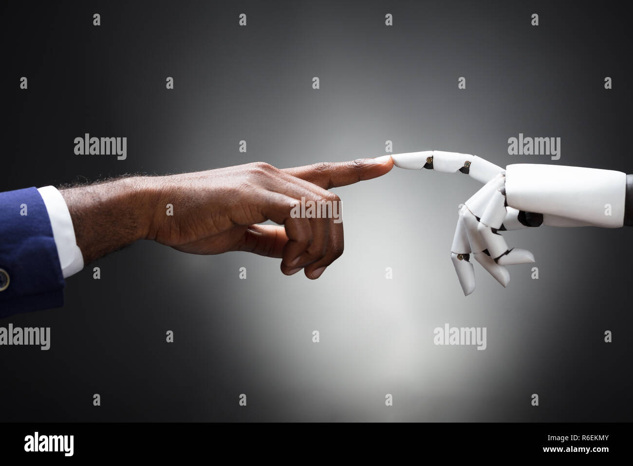 Fingers Of Robot And Man Touching Stock Photo - Alamy
