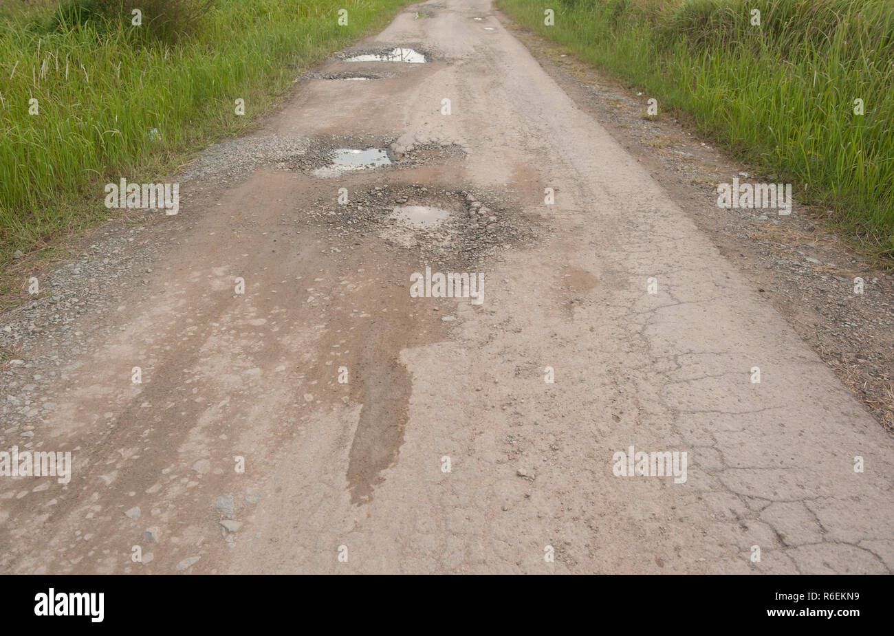 A rough and cracked village road Stock Photo - Alamy