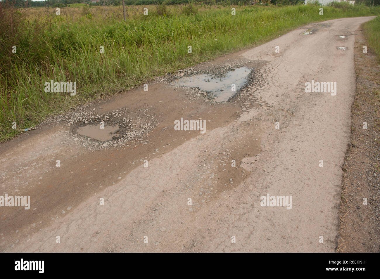 A rough and cracked village road Stock Photo - Alamy