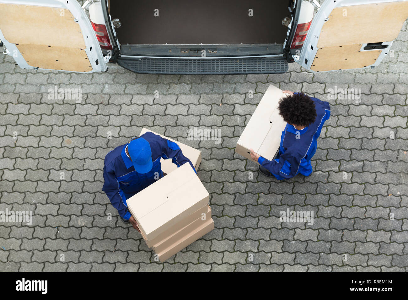 Delivery man putting carton boxes hi-res stock photography and images ...