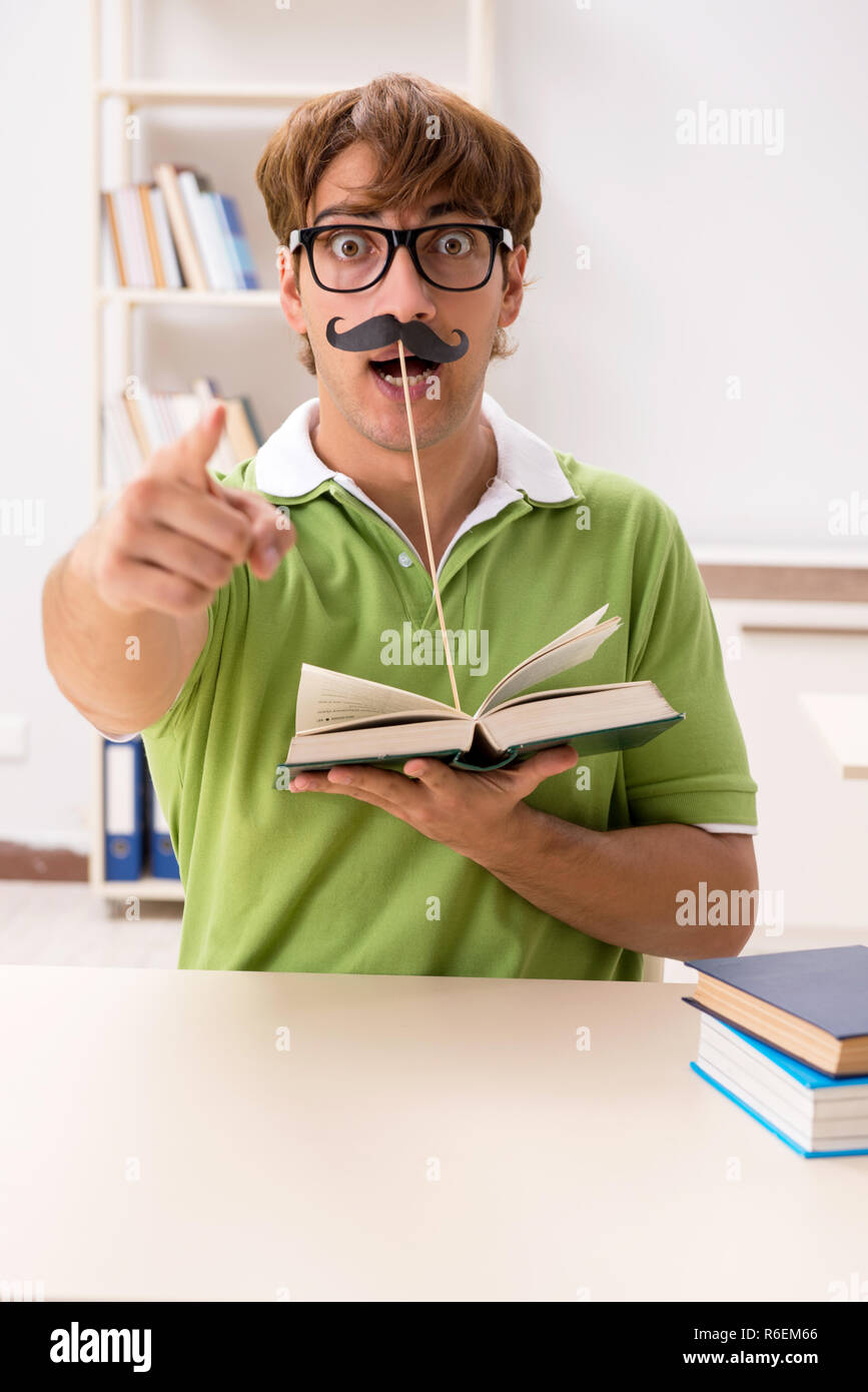 Student with fake moustache reading book Stock Photo - Alamy