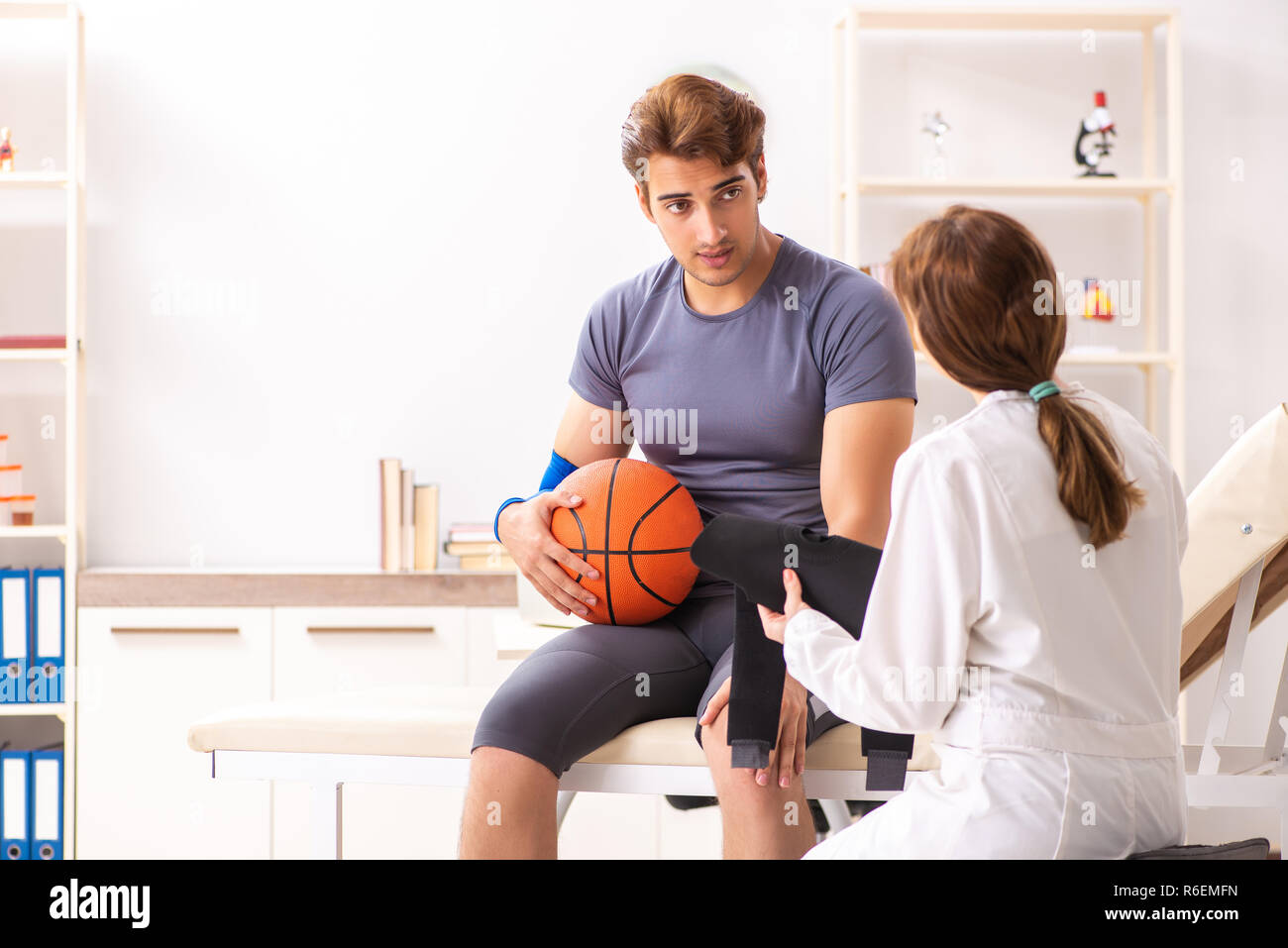 Handsome basketball player visiting female doctor traumatologist Stock ...