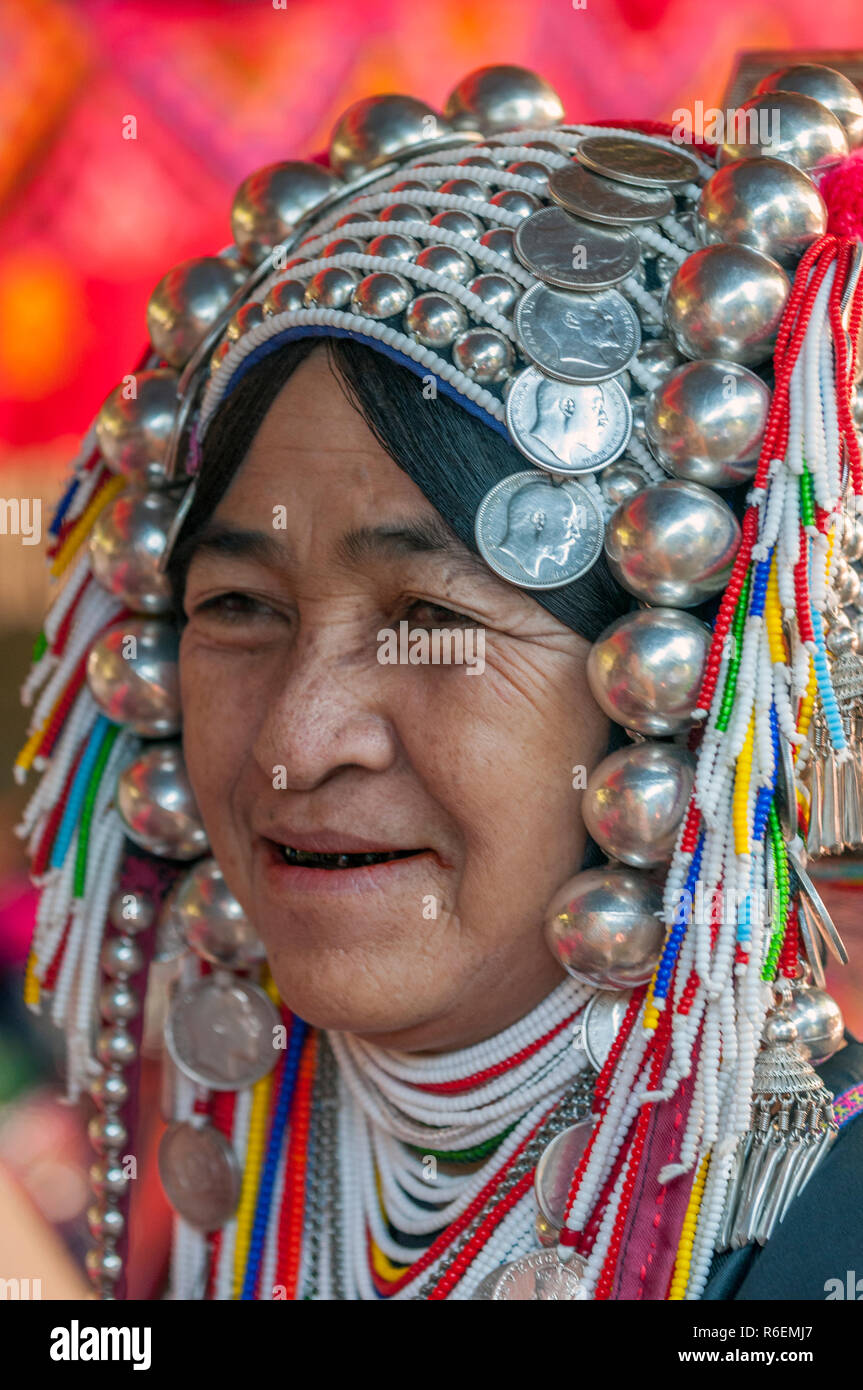 Akha Tribeswoman In Traditional Clothing And Wearing An Ornate ...