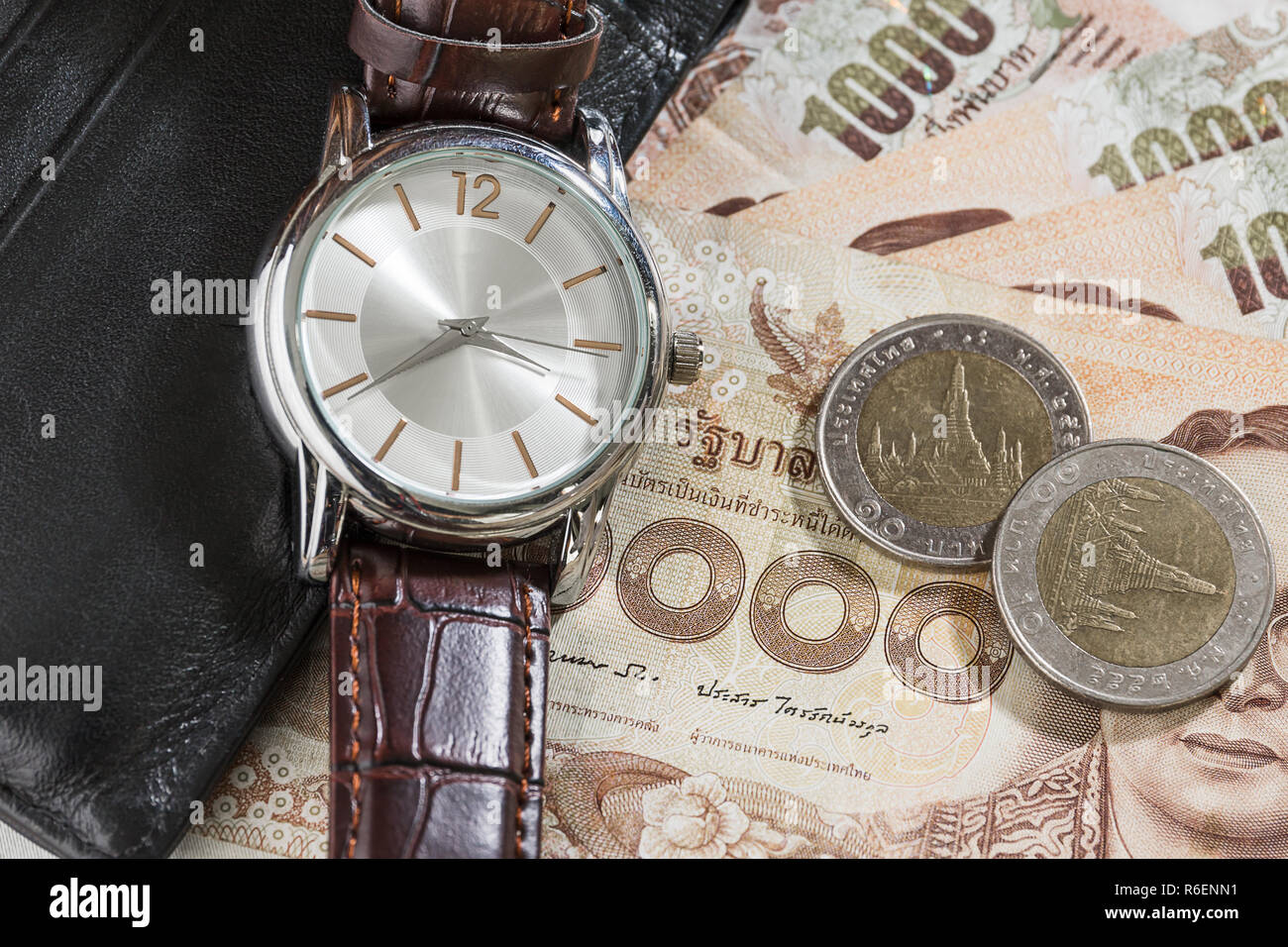 Watch and wallet on banknote Stock Photo - Alamy