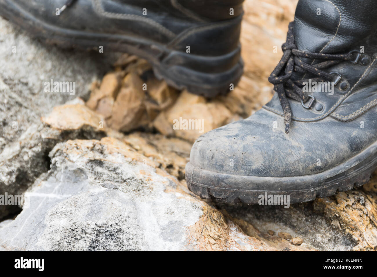 Trekking leather boot on the rock Stock Photo - Alamy