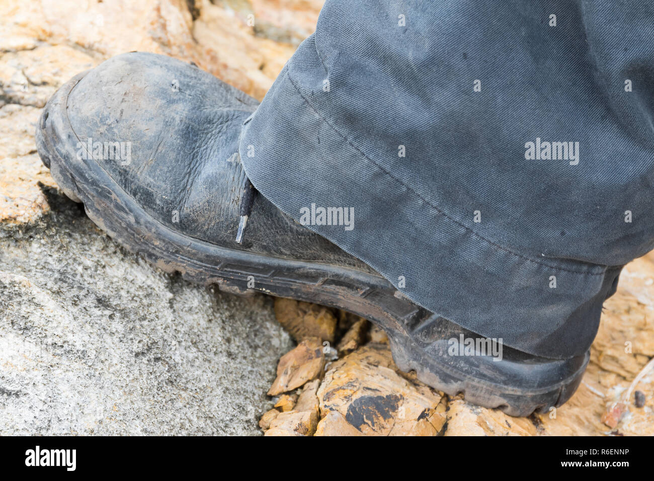 Trekking leather boot on the rock Stock Photo - Alamy