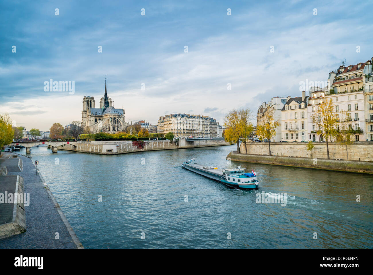 Notre-dame-de-Paris, the Seine river and a boat Stock Photo - Alamy