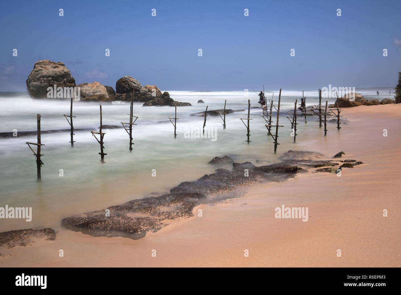 the beach at koggala with the stilt fishermen of sri lanka Stock Photo ...