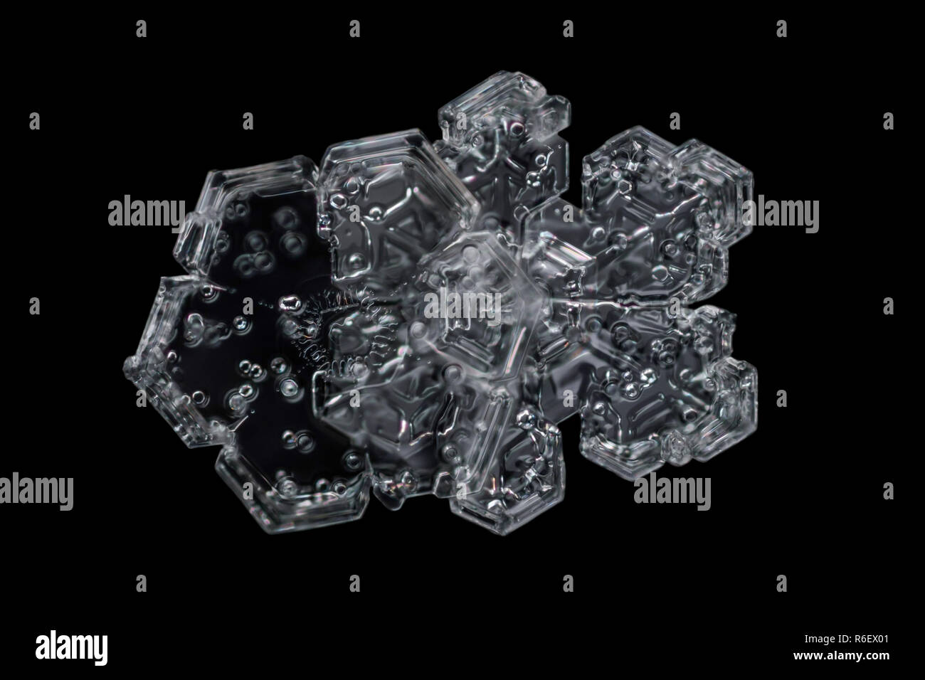 Extreme magnification - Real snowflake isolated on black background ...