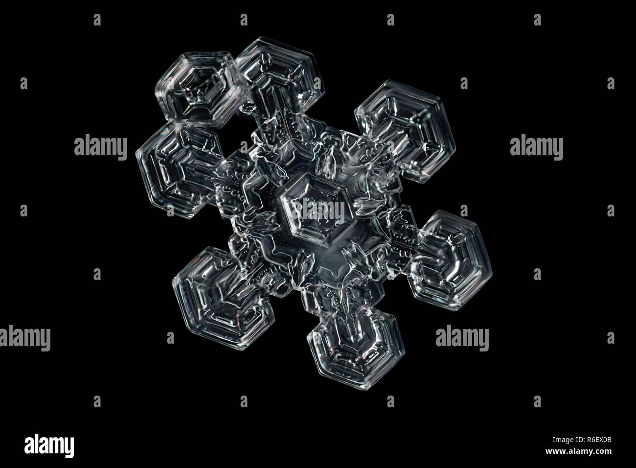 Extreme magnification - Real snowflake isolated on black background ...