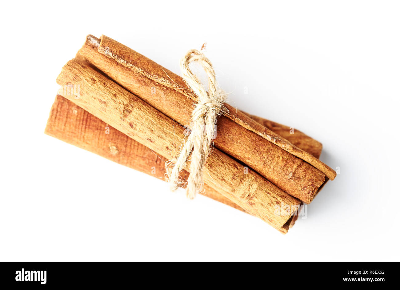 Cinnamon sticks related with rope isolated over white background. Food ...
