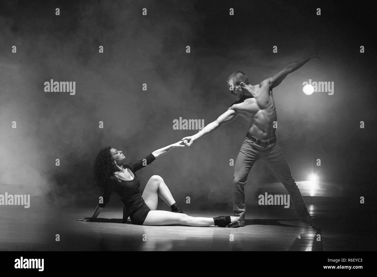 A man and a woman performing a contemporary dance pose on a stage Stock ...