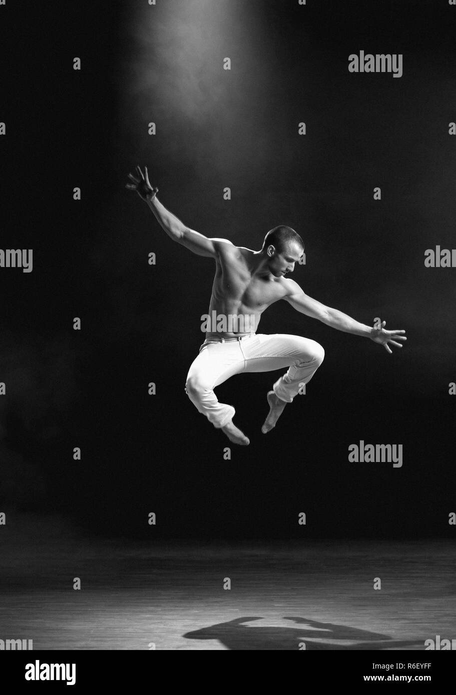 Fit young man jumping Black and White Stock Photos & Images - Alamy