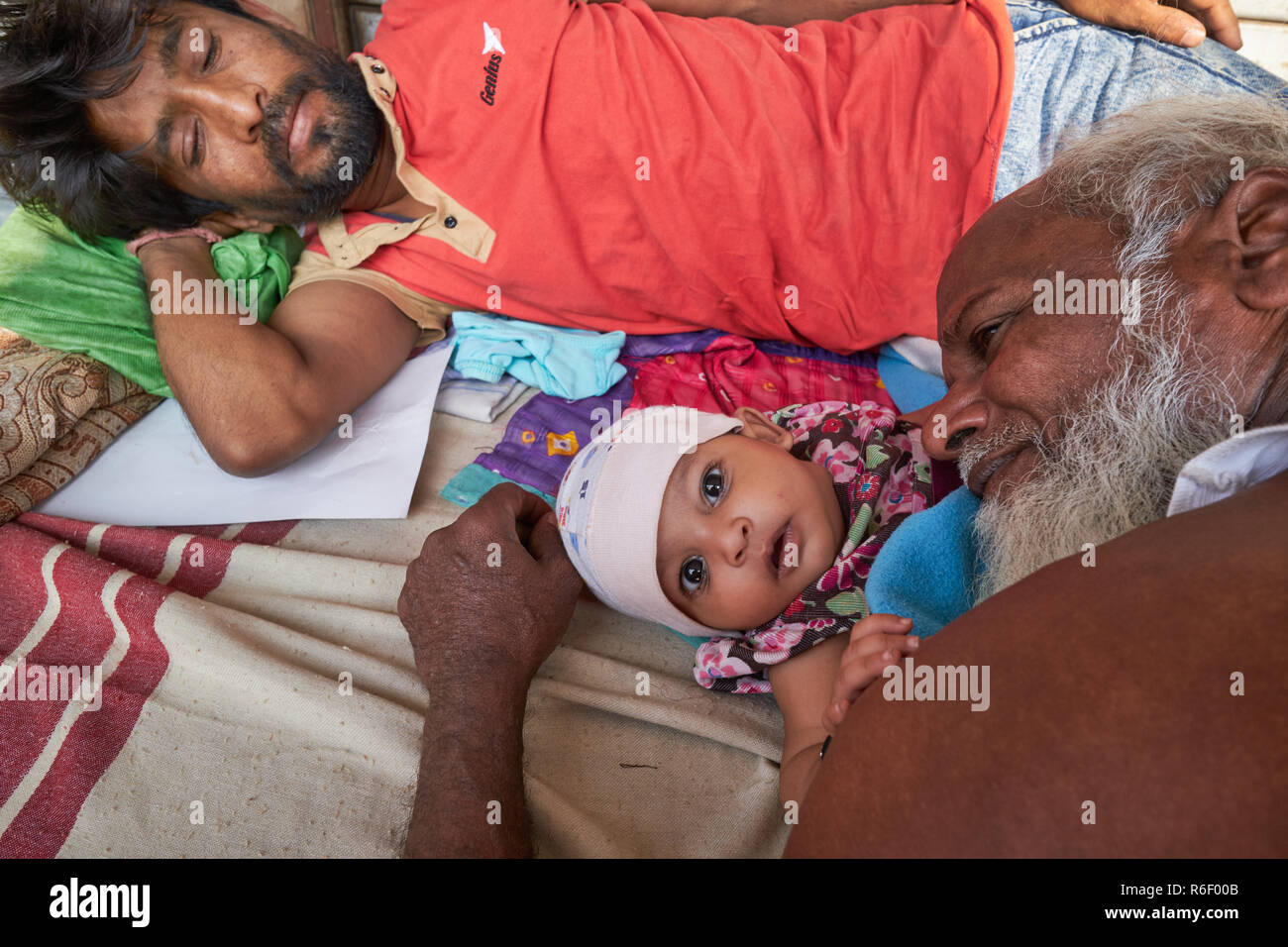 Members of a family of so-called pavement dwellers in Mumbai, India ...