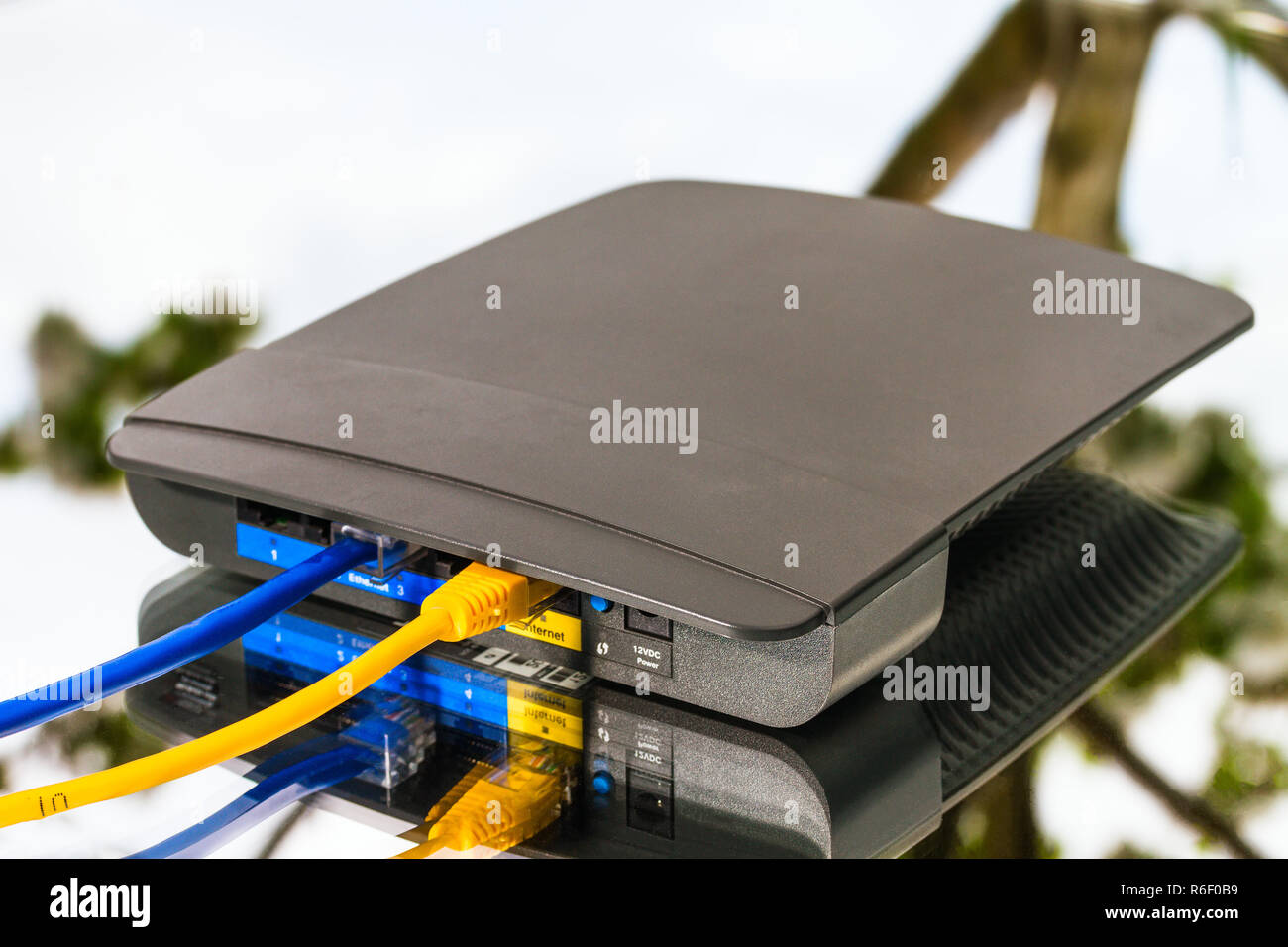wireless router, yellow and blue ethernet cables Stock Photo - Alamy