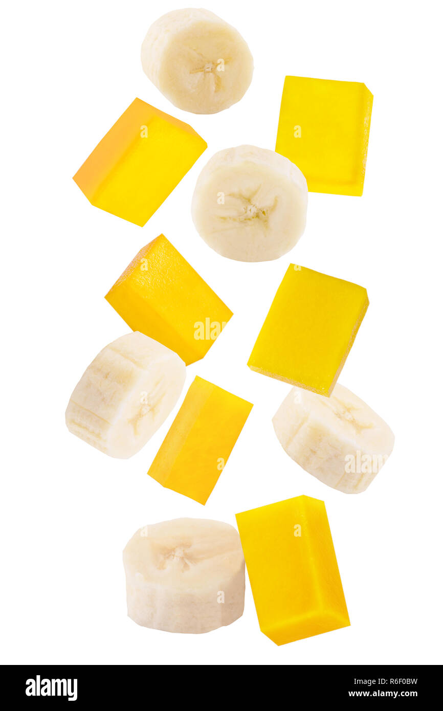 Falling sliced banana and mango isolated on white Stock Photo - Alamy