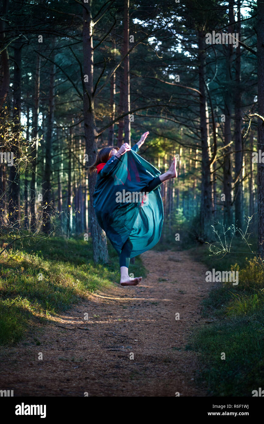 Beautiful, young woman levitating in woods. Flying in the dream. Lack ...