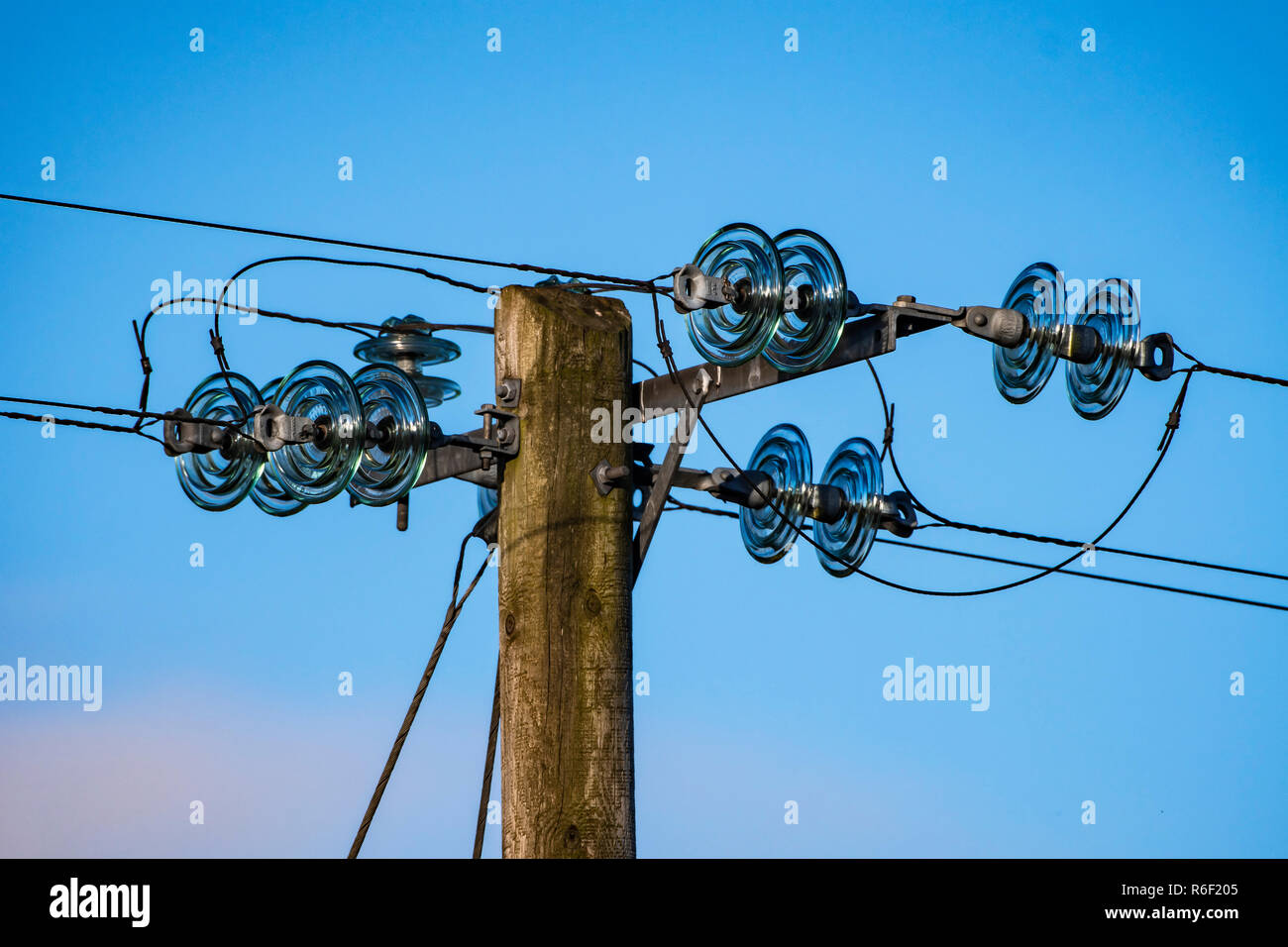 Electrical pole, with glass insulators Stock Photo - Alamy