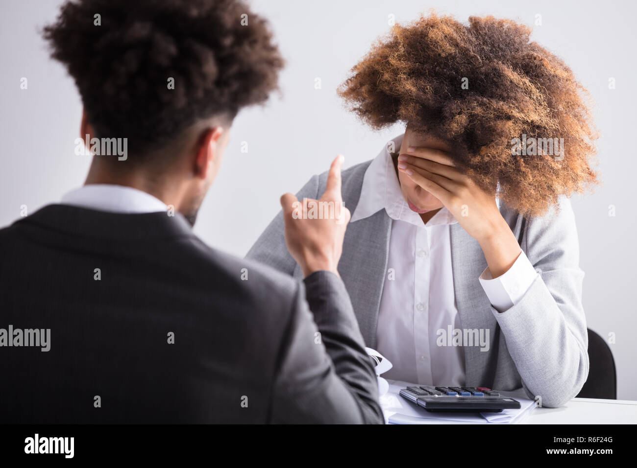 Businessman Pointing At His Female Employee Stock Photo - Alamy