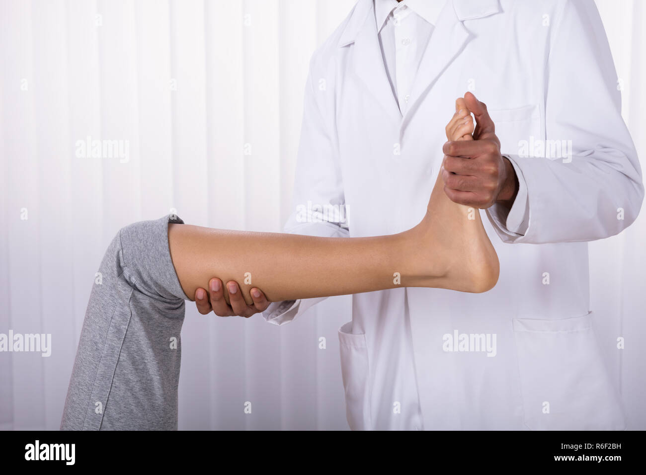 Physiotherapist Giving Leg Exercise To Patient Stock Photo - Alamy