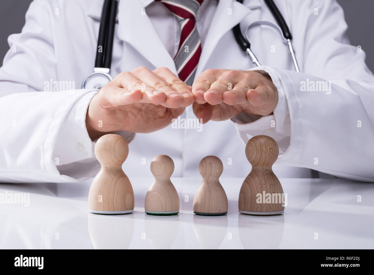 Doctor Protecting Family Stock Photo - Alamy
