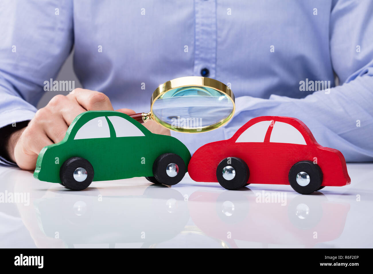 Looking At Red And Green Car Through Magnifying Glass Stock Photo - Alamy
