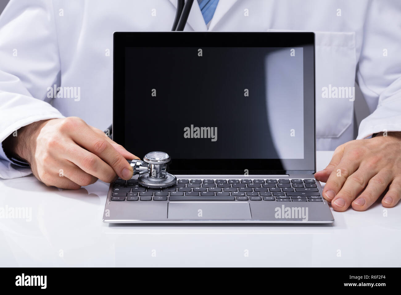 Doctor Examining Laptop With Stethoscope Stock Photo - Alamy