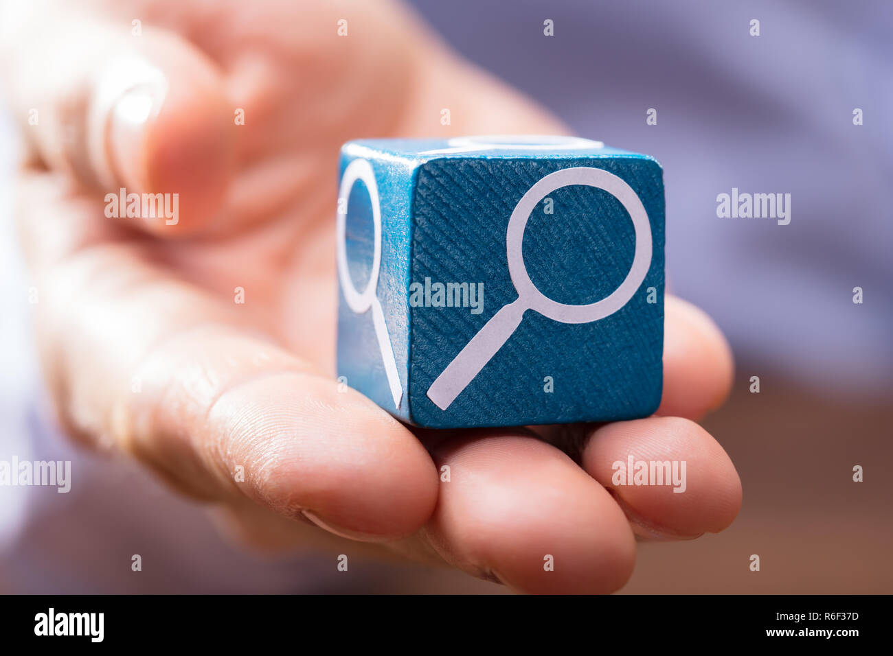 Person's Hand Holding Blue Wooden Block Stock Photo - Alamy