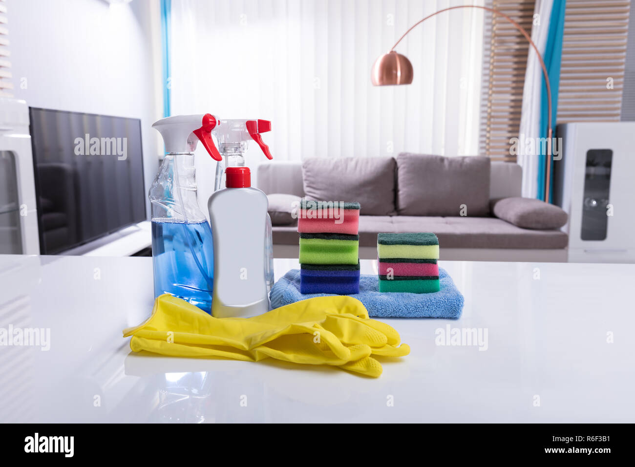 Different Cleaning Spray Bottles On White Desk Stock Photo - Alamy