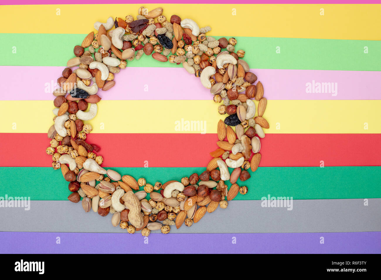 Pattern of nuts in circle form. Various nuts on colorful paper ...