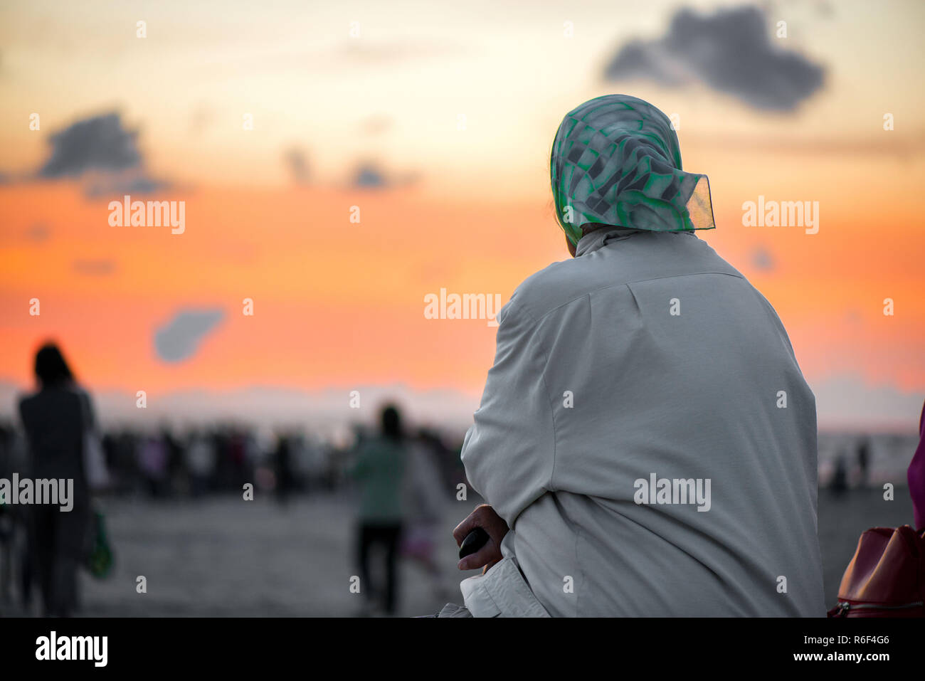 Old woman sitting at the seaside and watching romantic sunset Stock ...