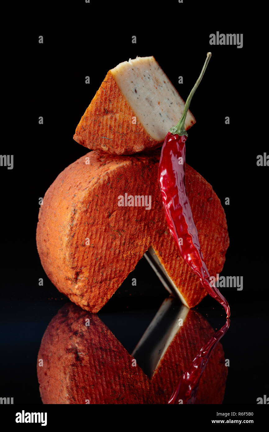 Red Pecorino sheep milk cheese with spices and red pepper. Traditional ...