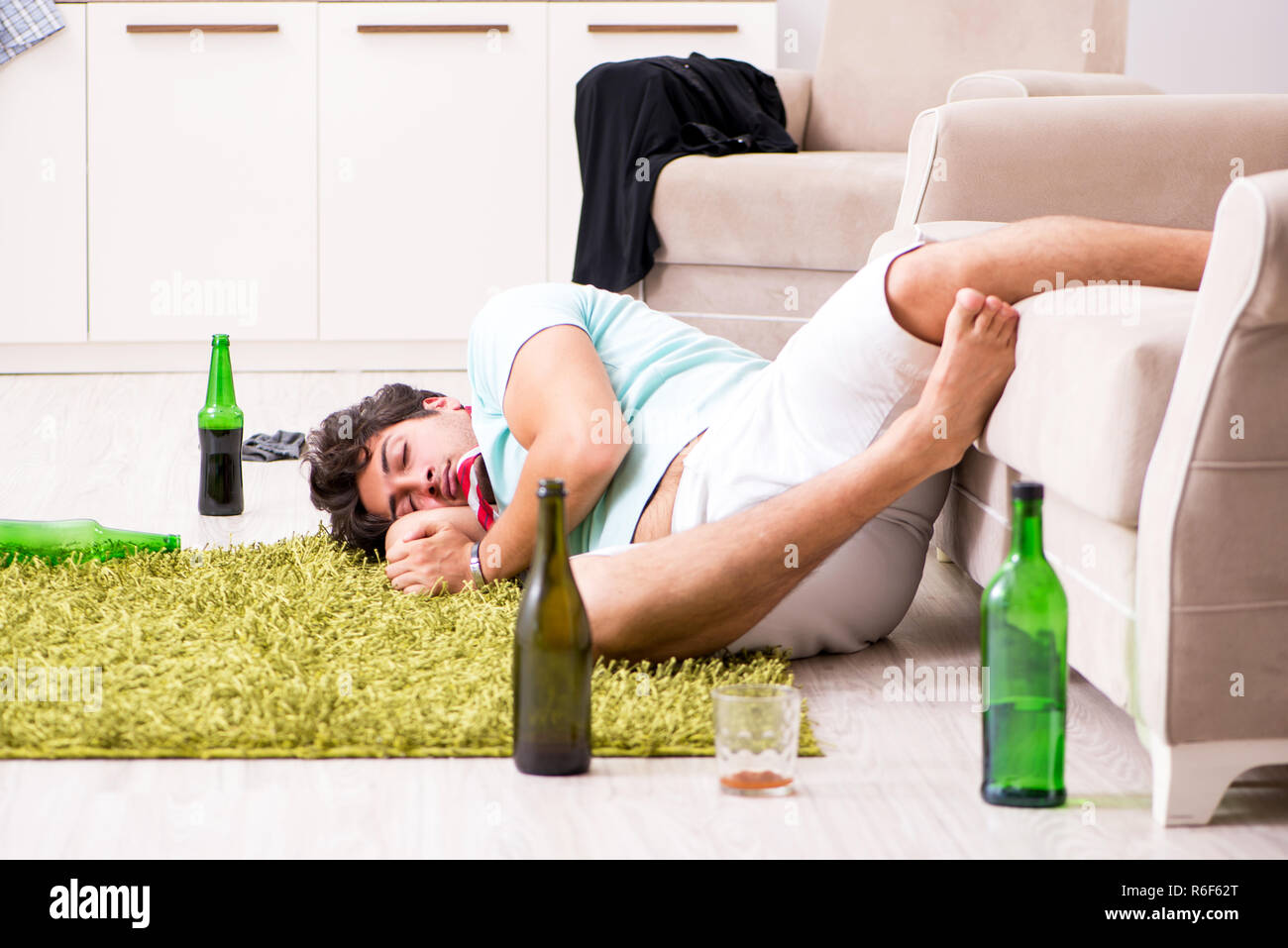 Young drunk handsome man after party at home Stock Photo - Alamy