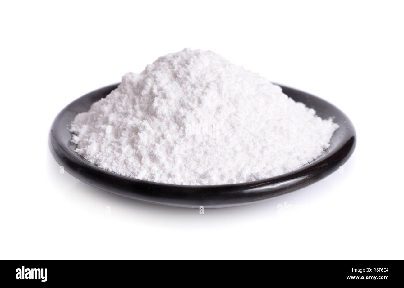 Sugar powdered on plate. Isolated on white background Stock Photo - Alamy