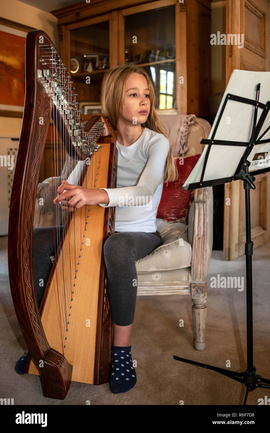 Child playing harp hi-res stock photography and images - Alamy