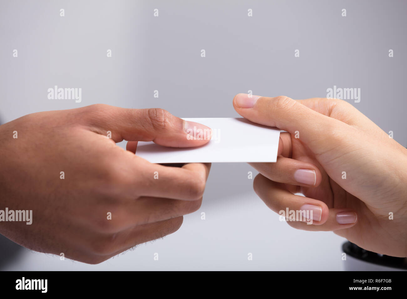 Two Businesspeople Holding Card Stock Photo - Alamy