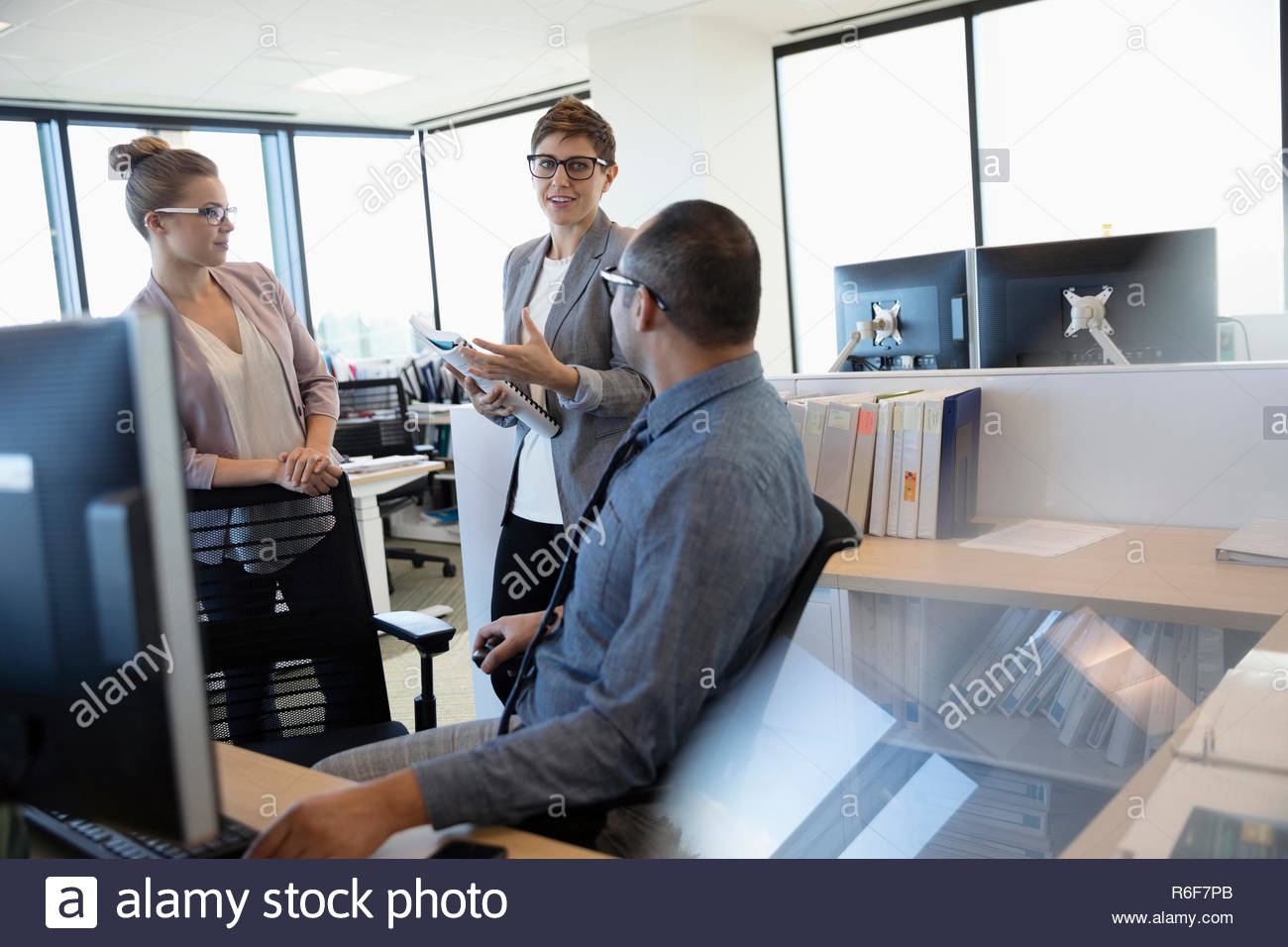 Business people talking in office cubicle Stock Photo - Alamy