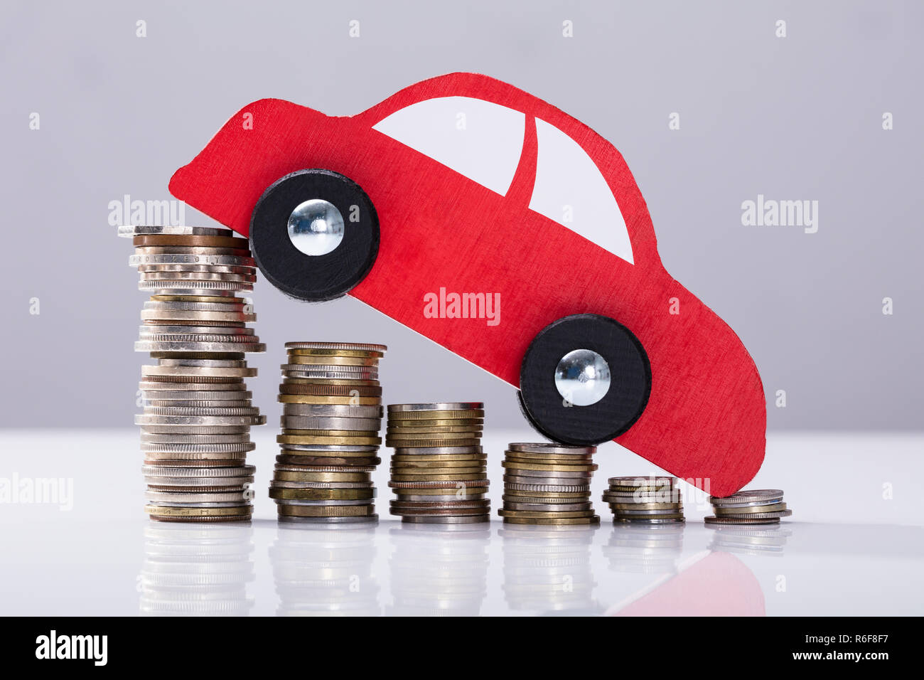 Car Model Over a Stacked Coin Stock Photo - Alamy
