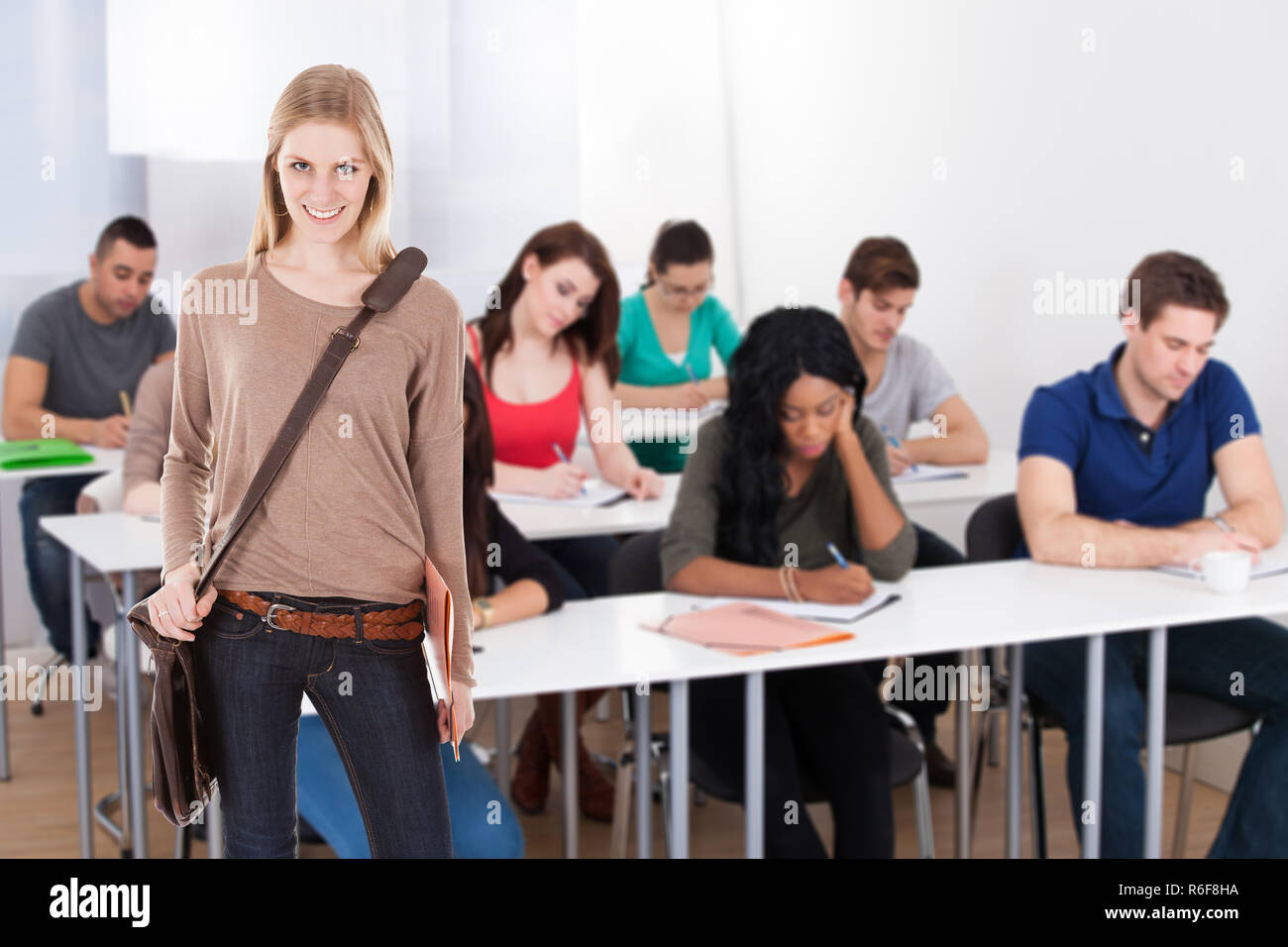 Confident Student Standing Against White Background Stock Photo - Alamy