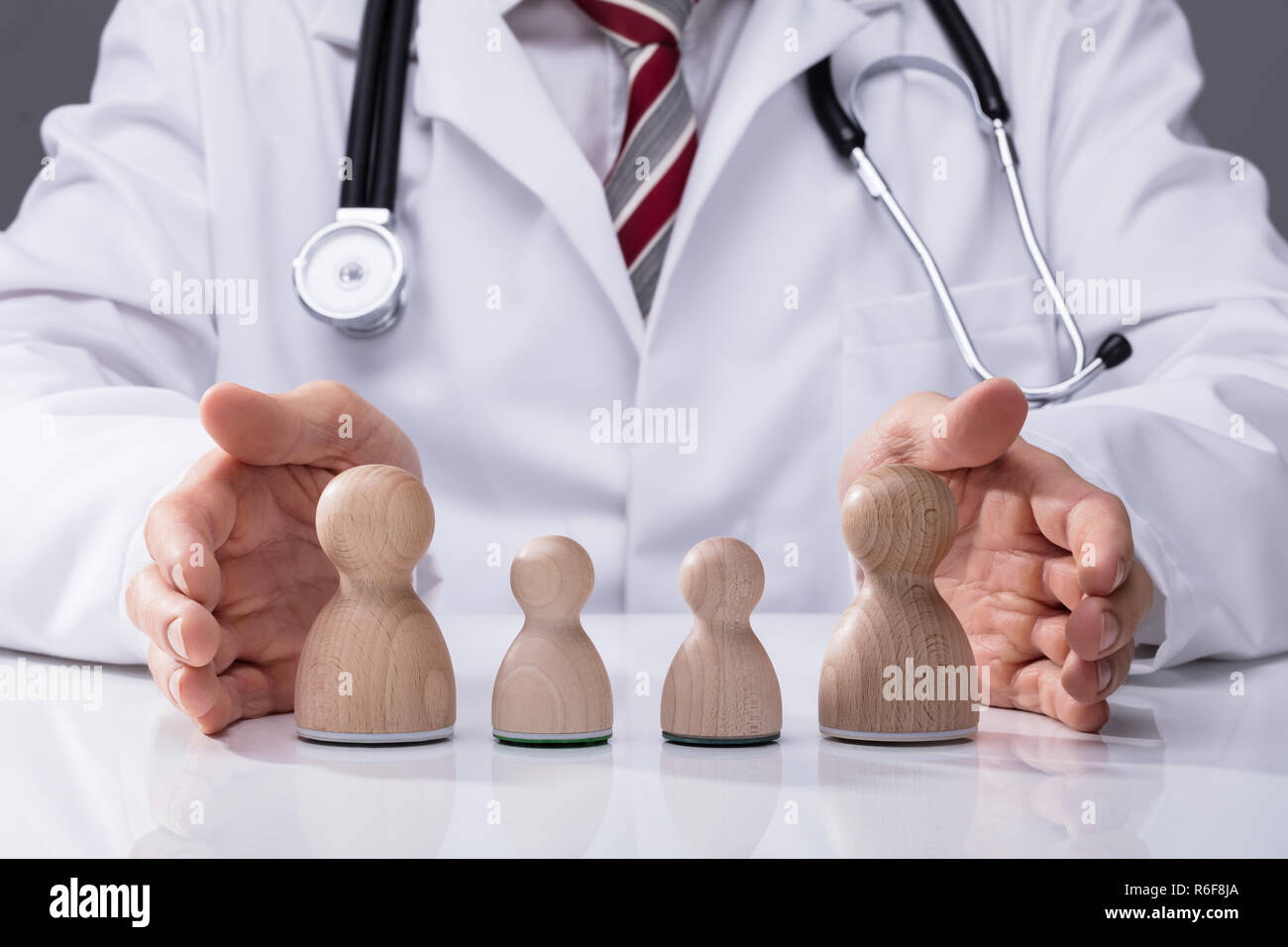 Doctor Protecting Family Stock Photo - Alamy