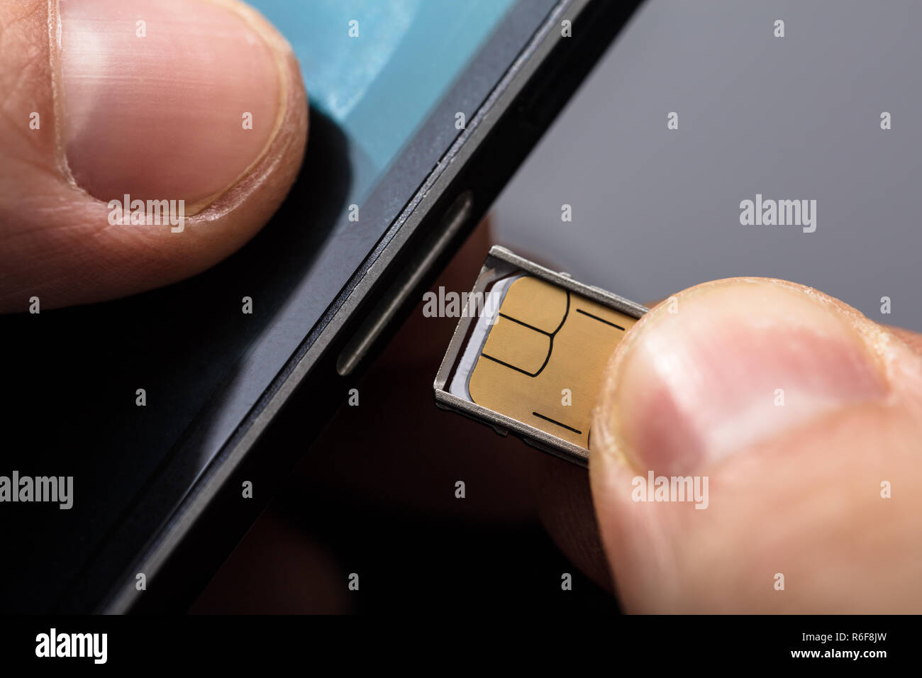 Inserting A Sim Card In A Mobile Phone Stock Photo - Alamy