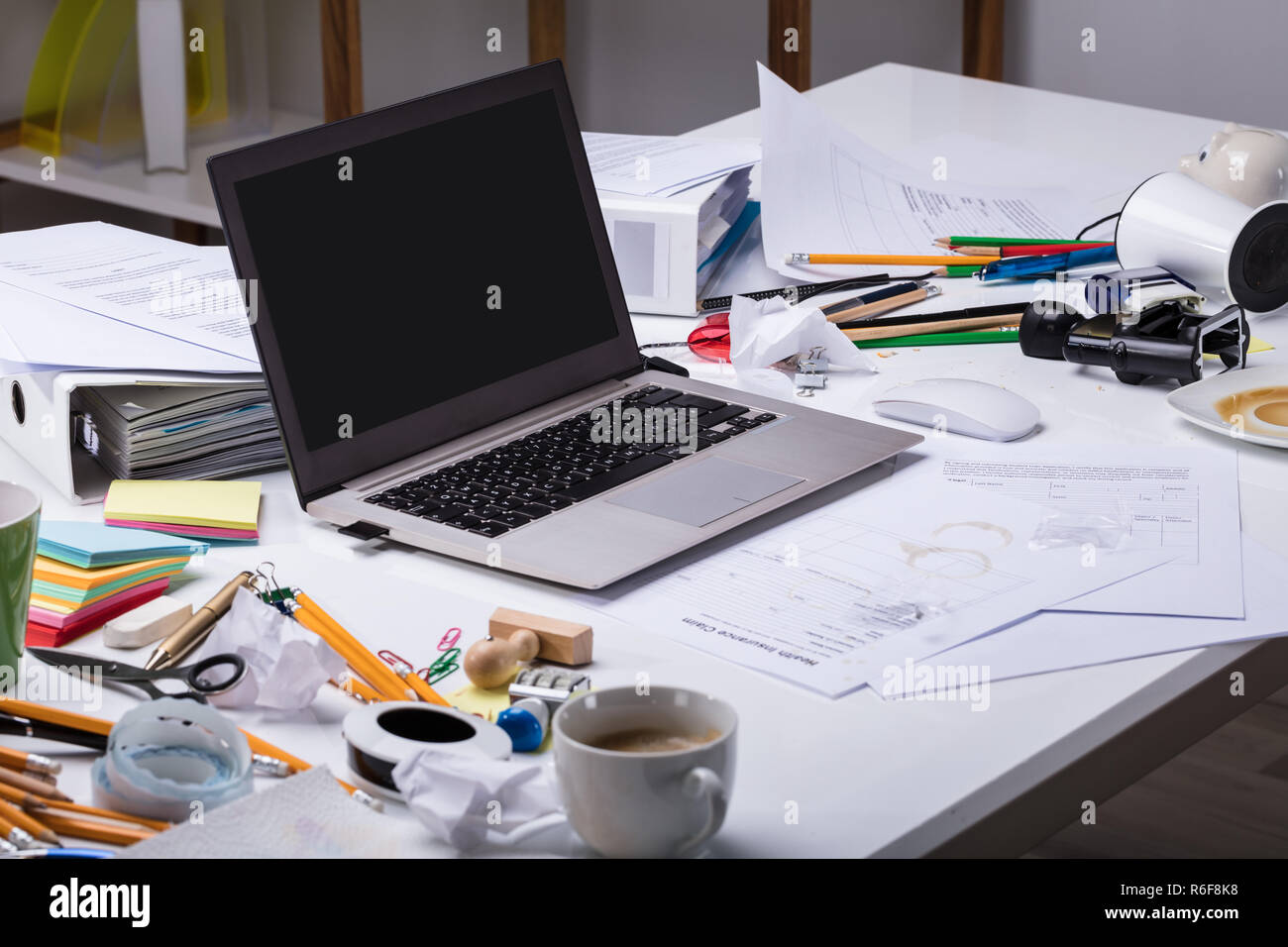 Open Laptop On The Messy Desk Stock Photo - Alamy