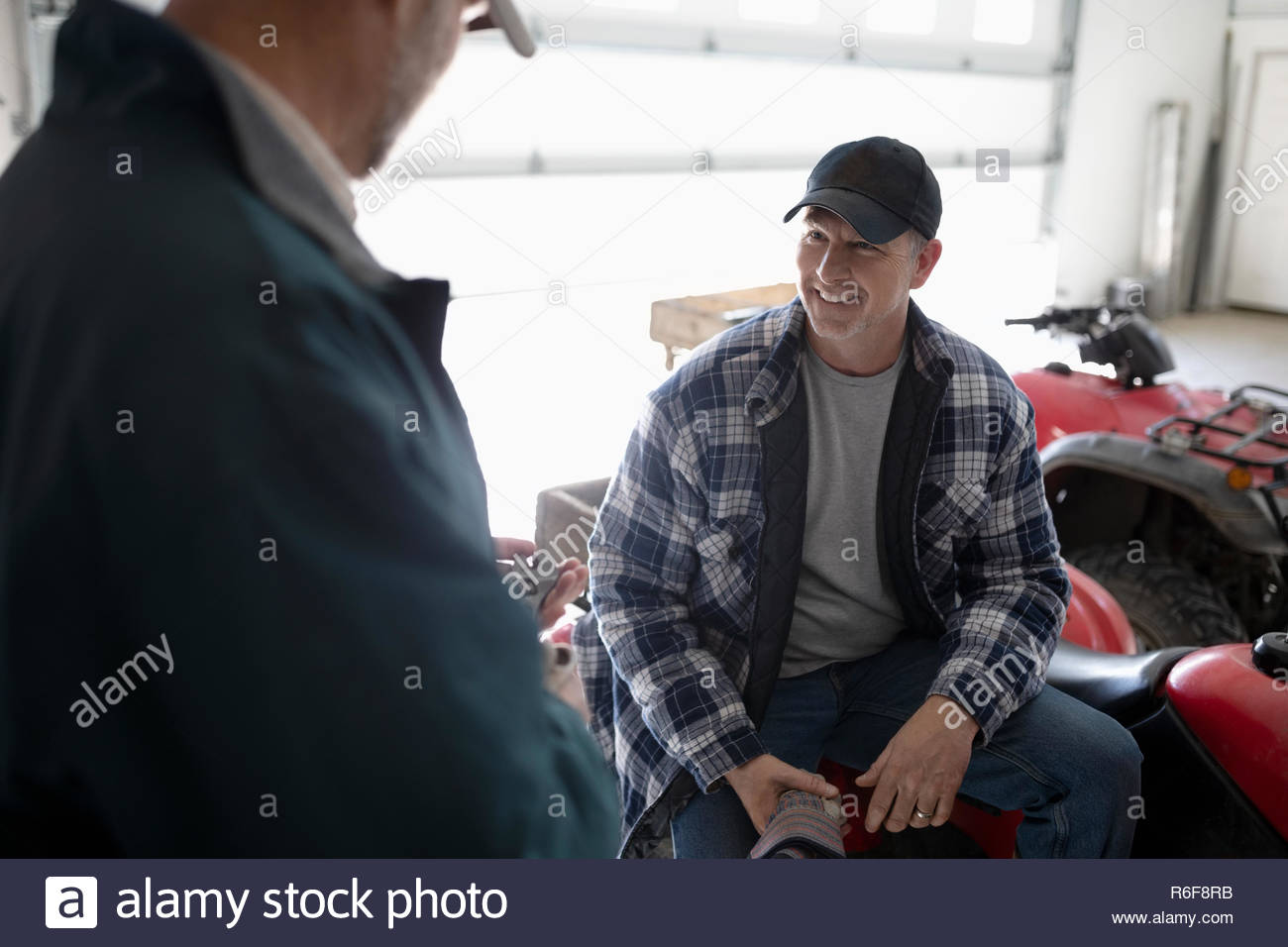 Male farmers talking in barn Stock Photo - Alamy