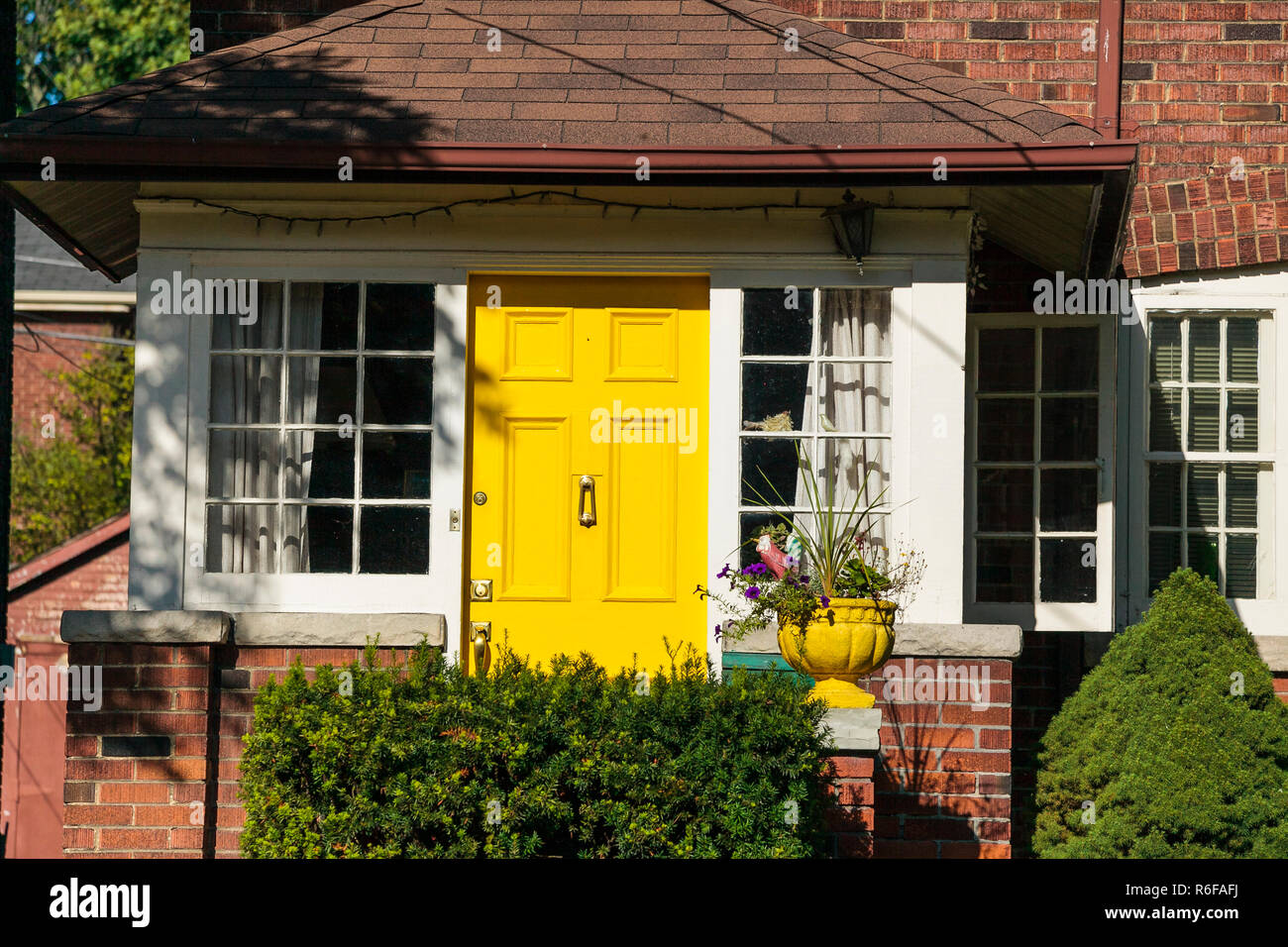 Habitation with shingles roof and brick frame Stock Photo - Alamy