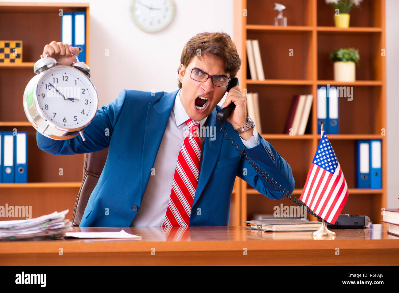 Young handsome politician sitting in office Stock Photo - Alamy