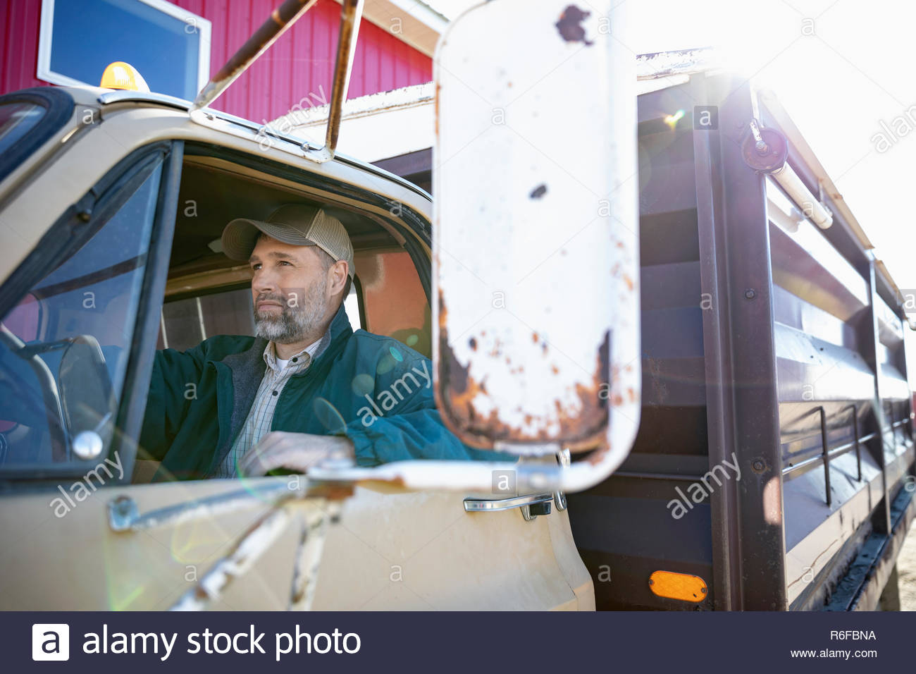 Male farmer driving trailer truck Stock Photo - Alamy