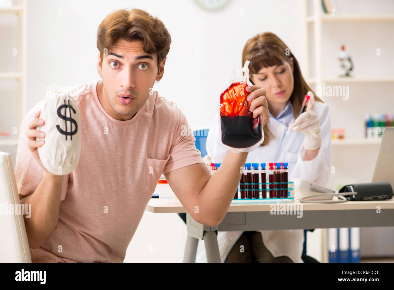 Man giving his blood as a donor Stock Photo - Alamy